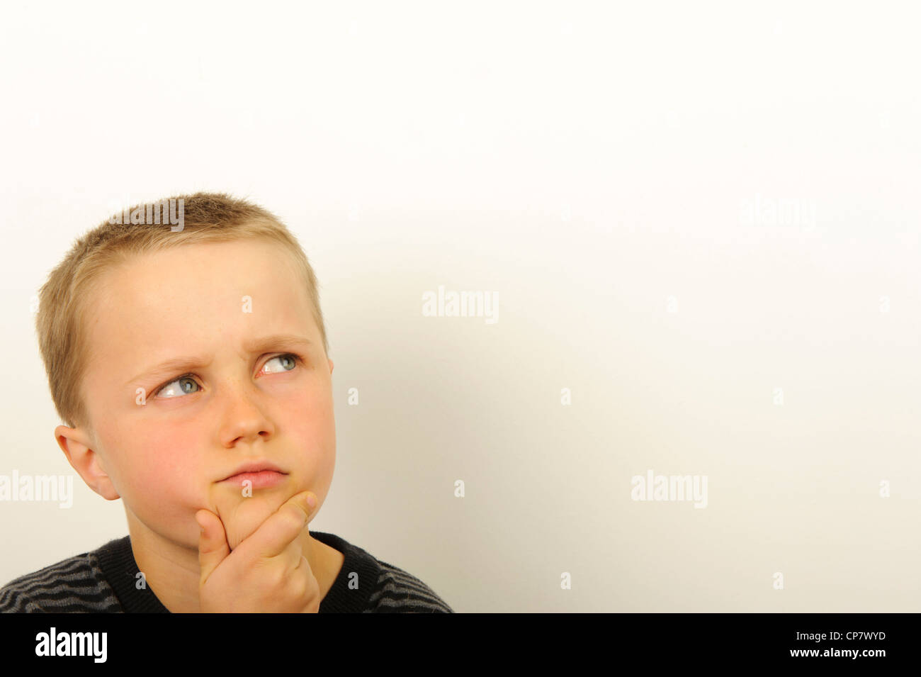 Stock Photo of a young boy thinking Stock Photo - Alamy