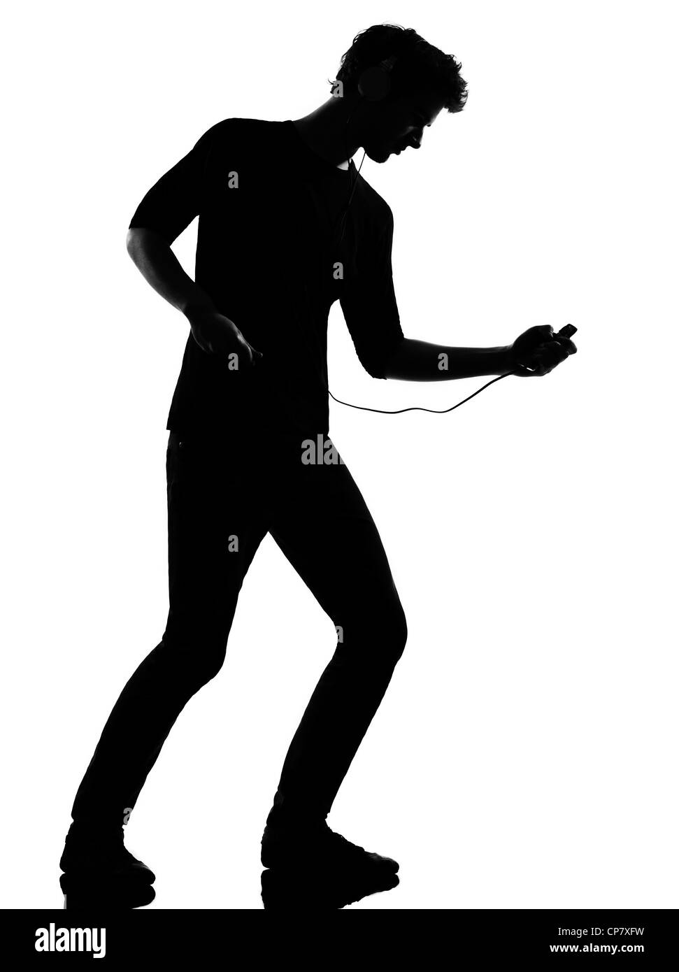 young man listening music audio player silhouette in studio isolated on ...
