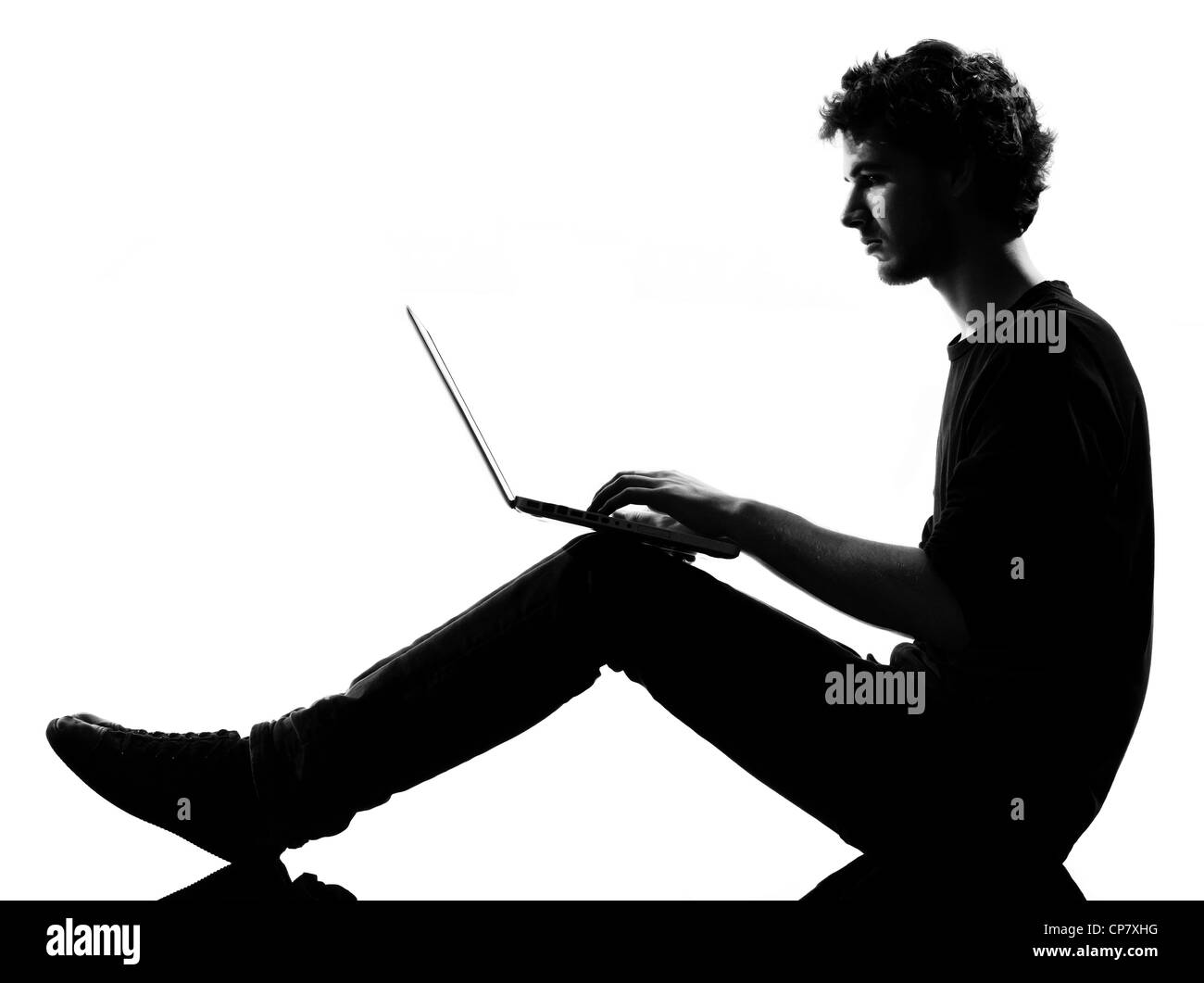young man silhouette silhouette sitting computing computer laptop in ...