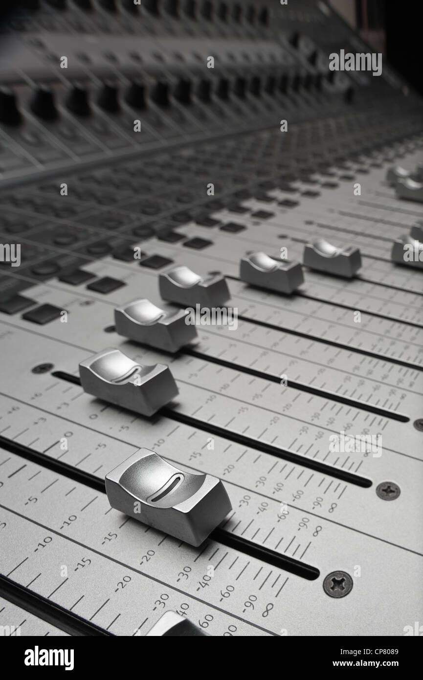 Electronic sound audio mixing desk console in recording studio showing ...
