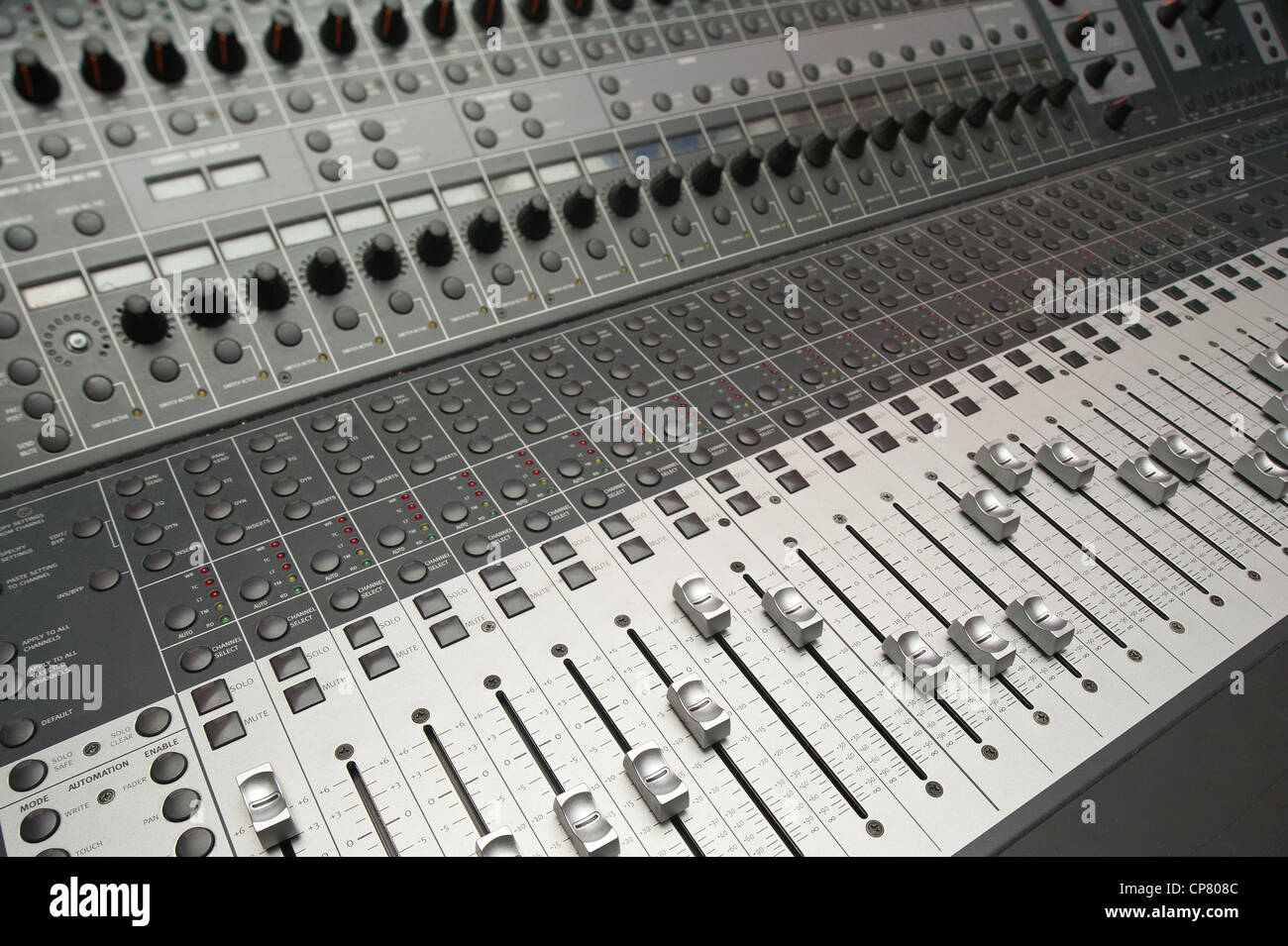 Electronic sound audio mixing desk console in recording studio showing ...