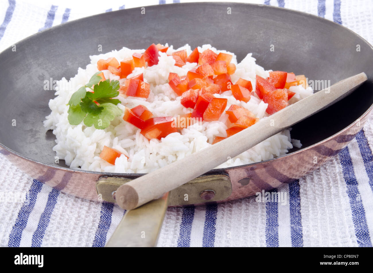 vegetarian rice pan with diced red bell pepper Stock Photo - Alamy