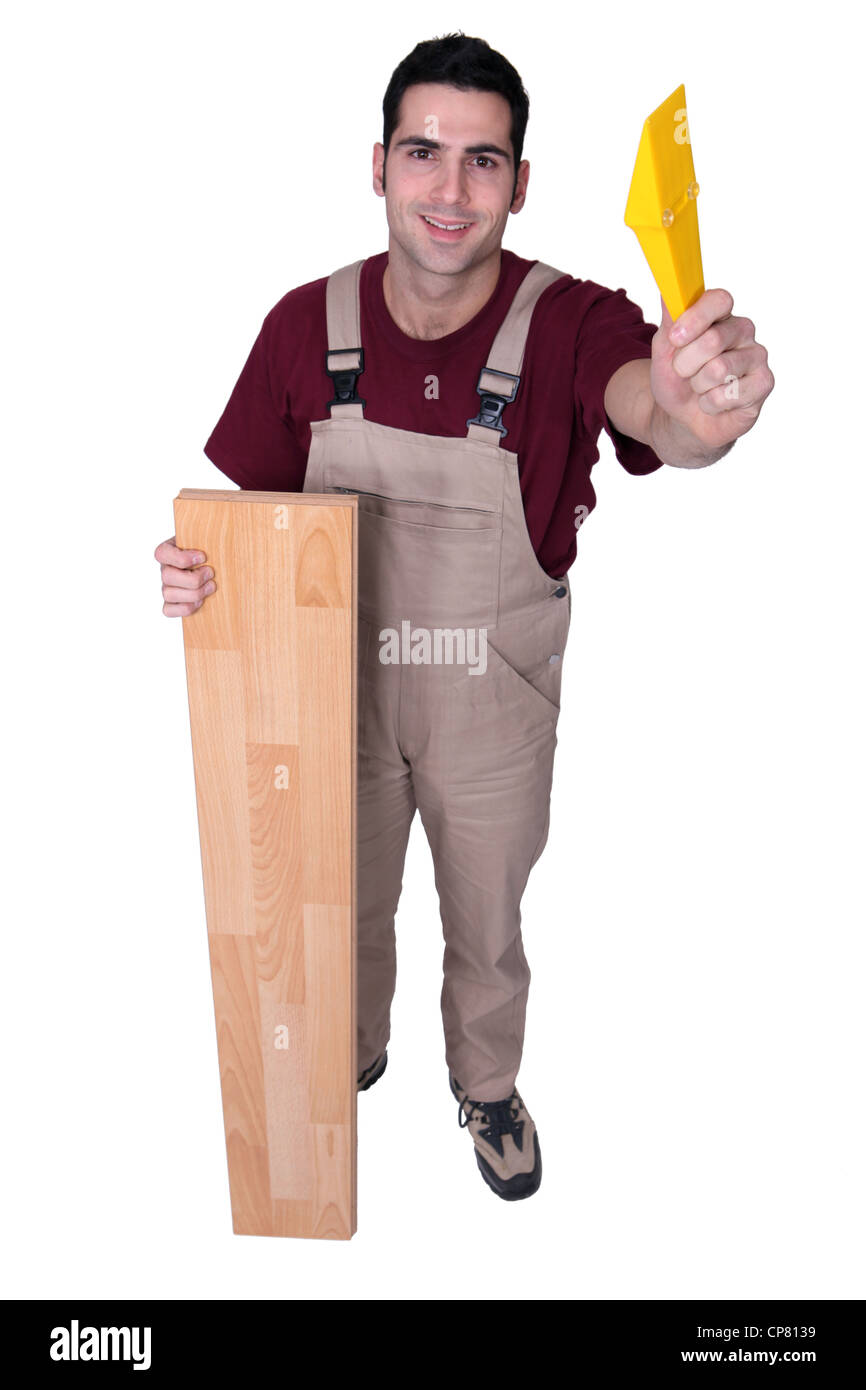 carpenter posing with floorboards and a float Stock Photo - Alamy