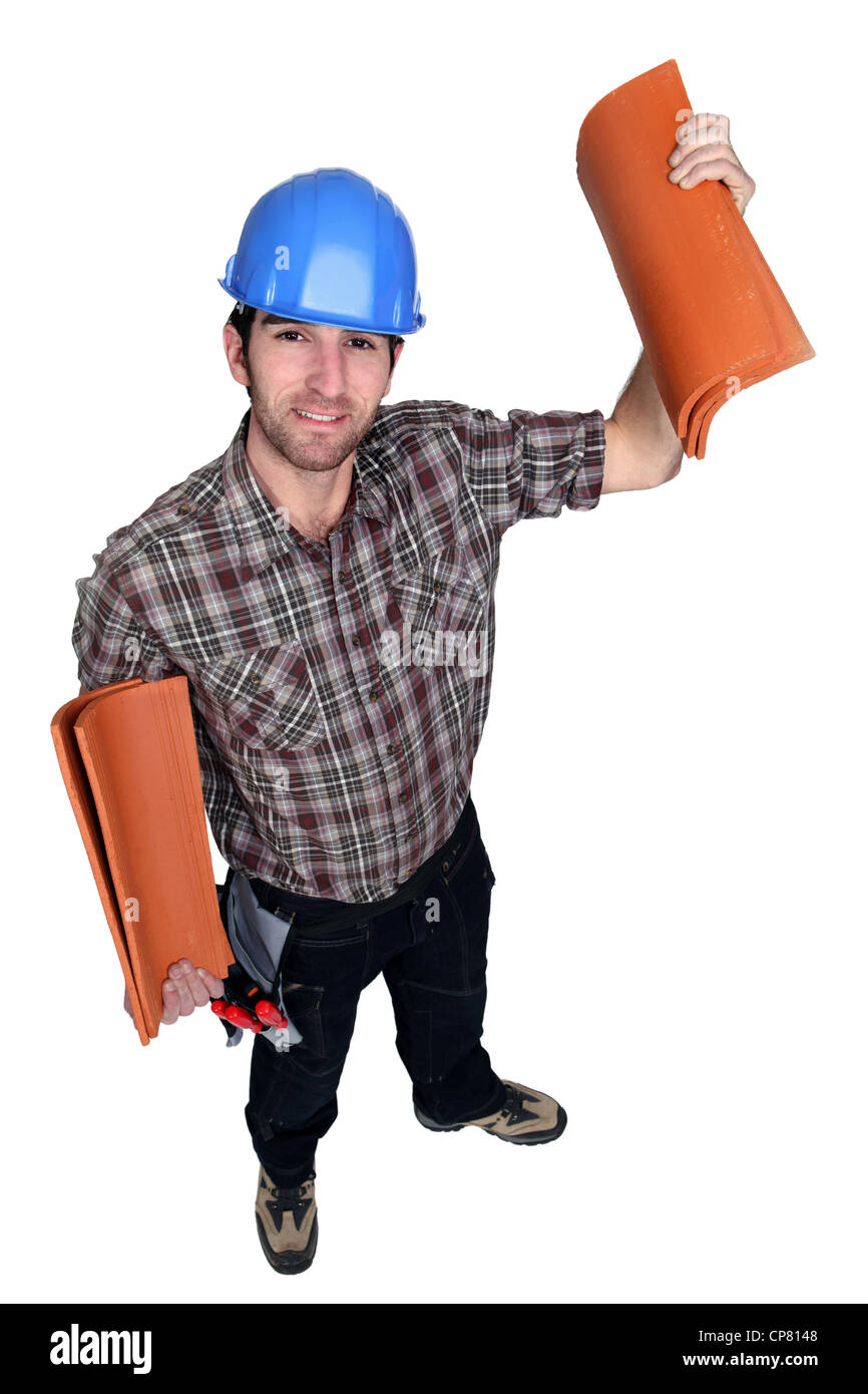 Man holding roof tiles Stock Photo - Alamy