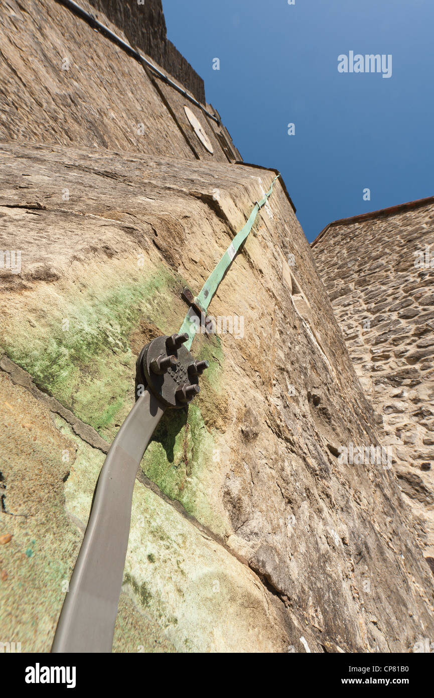 Copper lightning conductor strip running up a Kentish ragstone tower ...