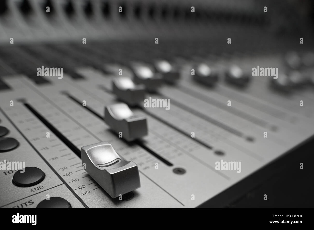 Electronic sound audio mixing desk console in recording studio showing ...