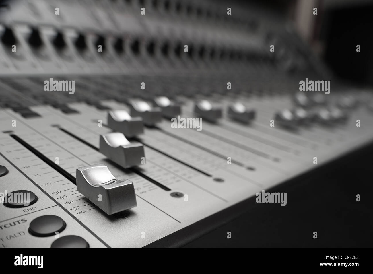 Electronic sound audio mixing desk console in recording studio showing ...