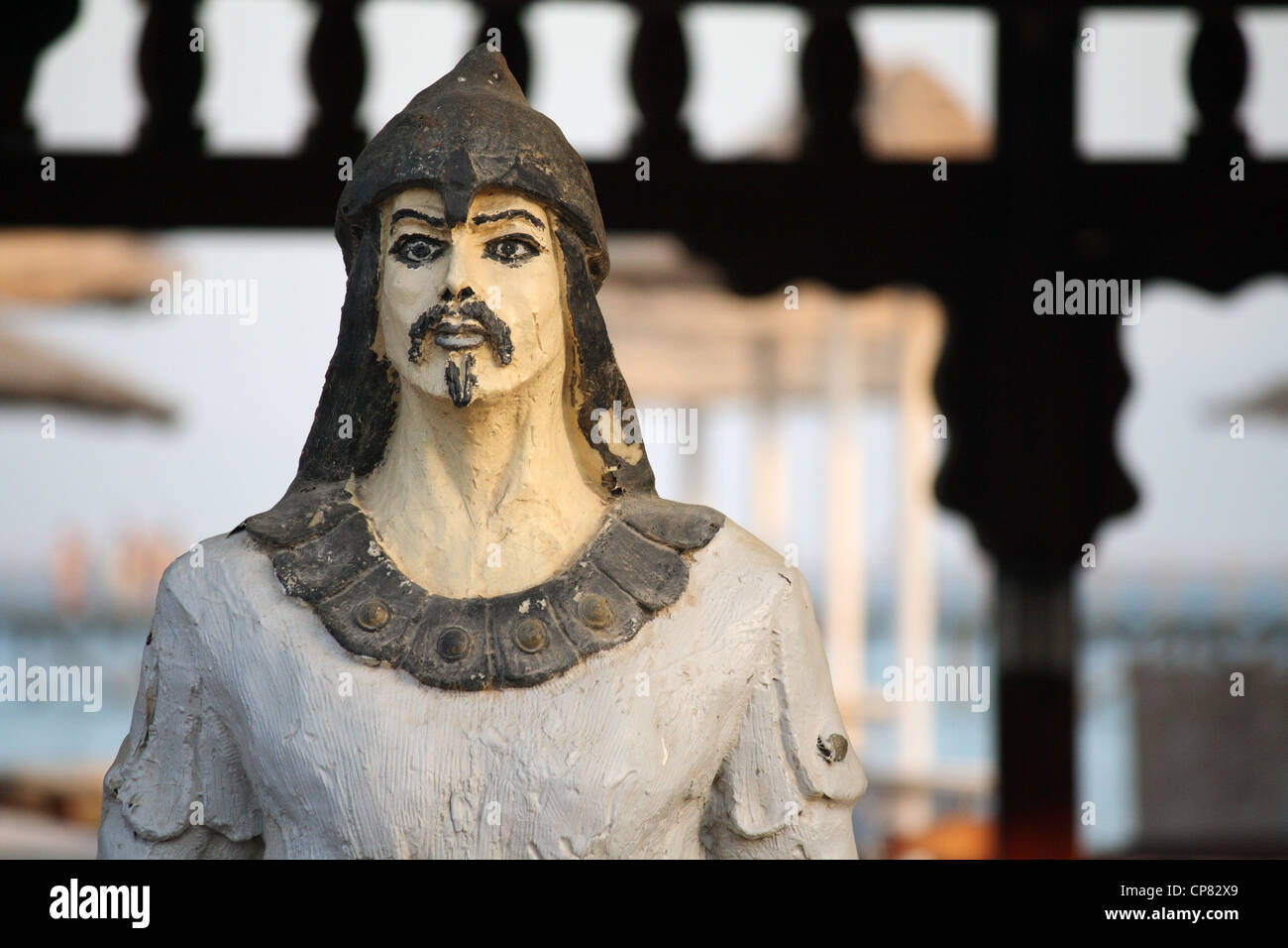 An ancient warrior statue in front of a gate Stock Photo - Alamy