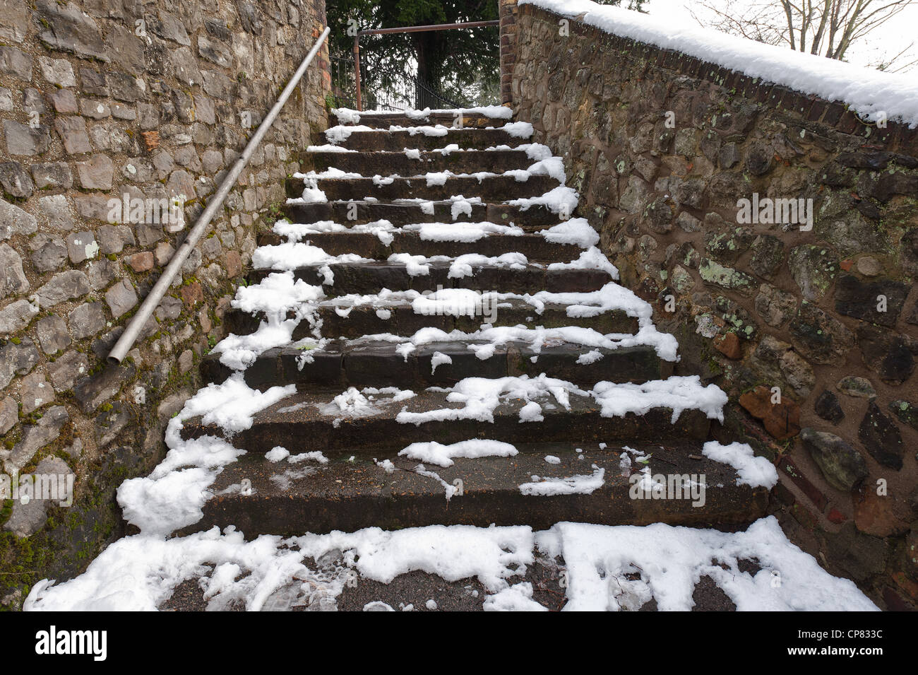 Kentish ragstone entrance steps covered with slush ice and snow create ...