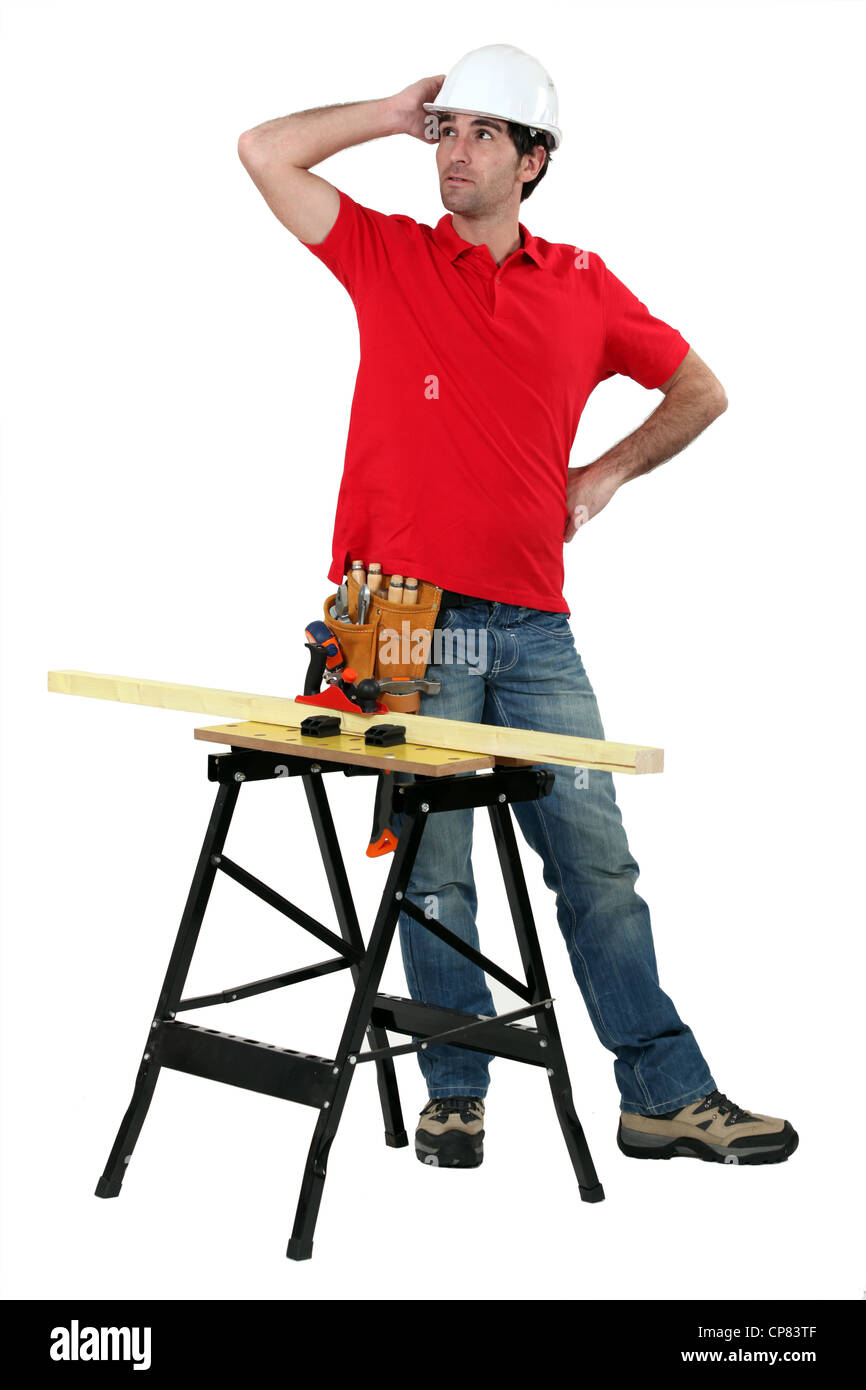 carpenter with workbench looking puzzled Stock Photo - Alamy