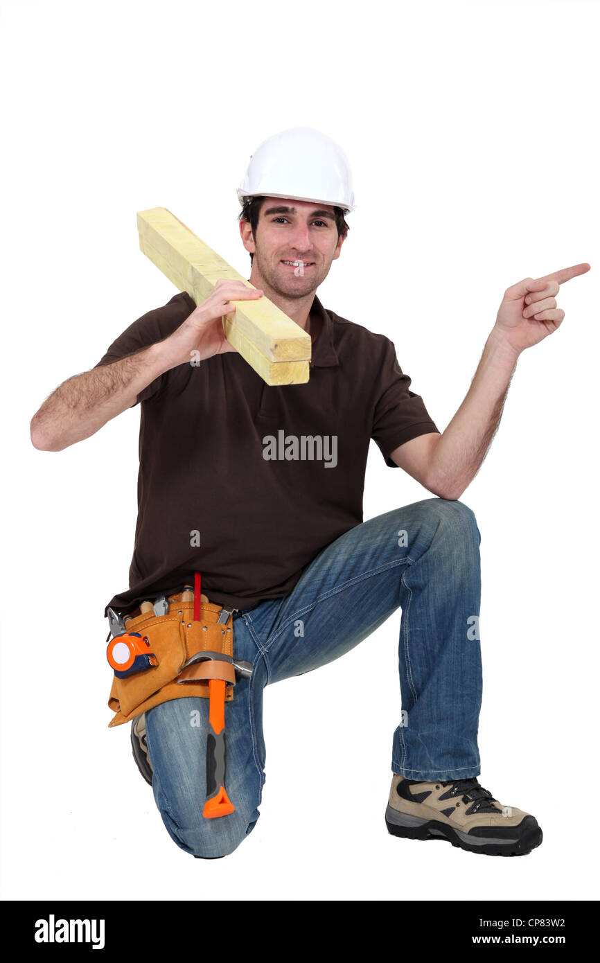 portrait of carpenter isolated pointing sidewards isolated on white ...