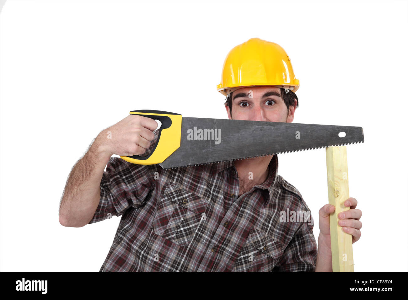 Tradesman hiding behind a saw Stock Photo - Alamy