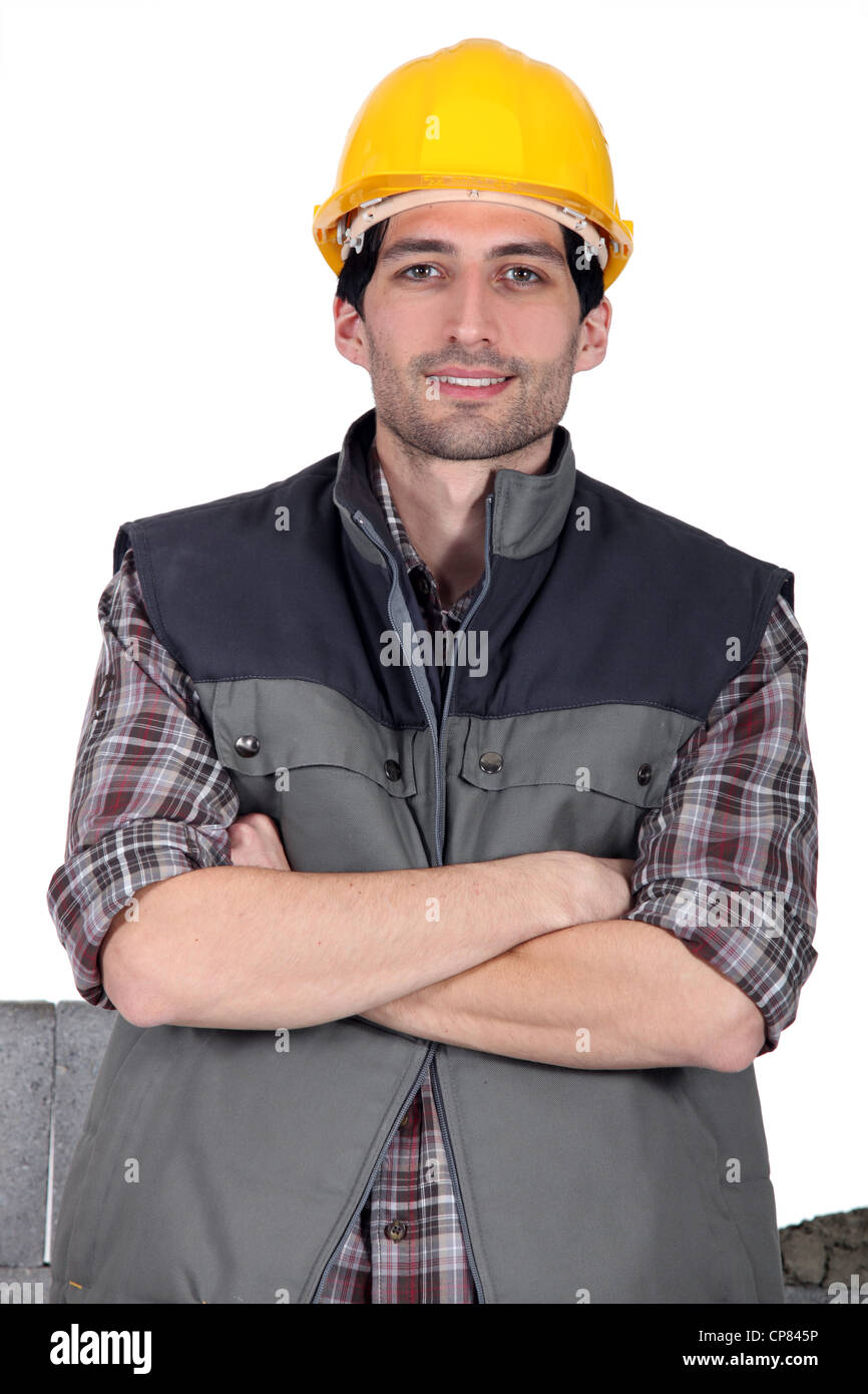Mason stood with his arms folded Stock Photo - Alamy