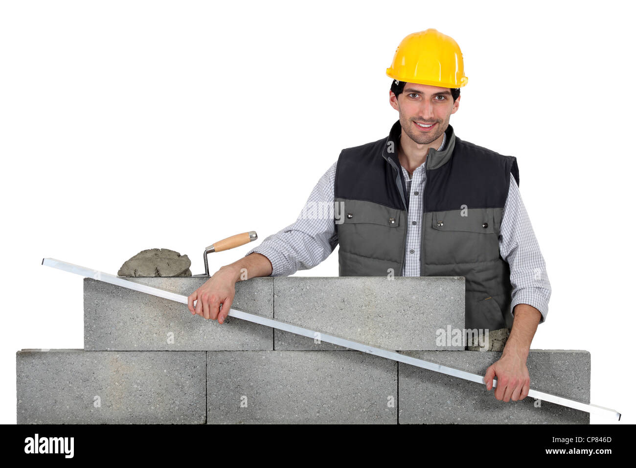 Bricklayer with a steel rule Stock Photo - Alamy
