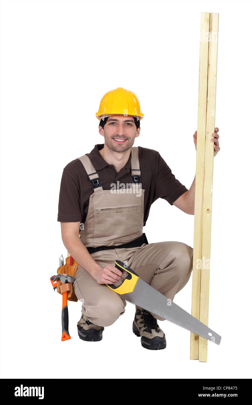 Carpenter with hand saw Stock Photo - Alamy