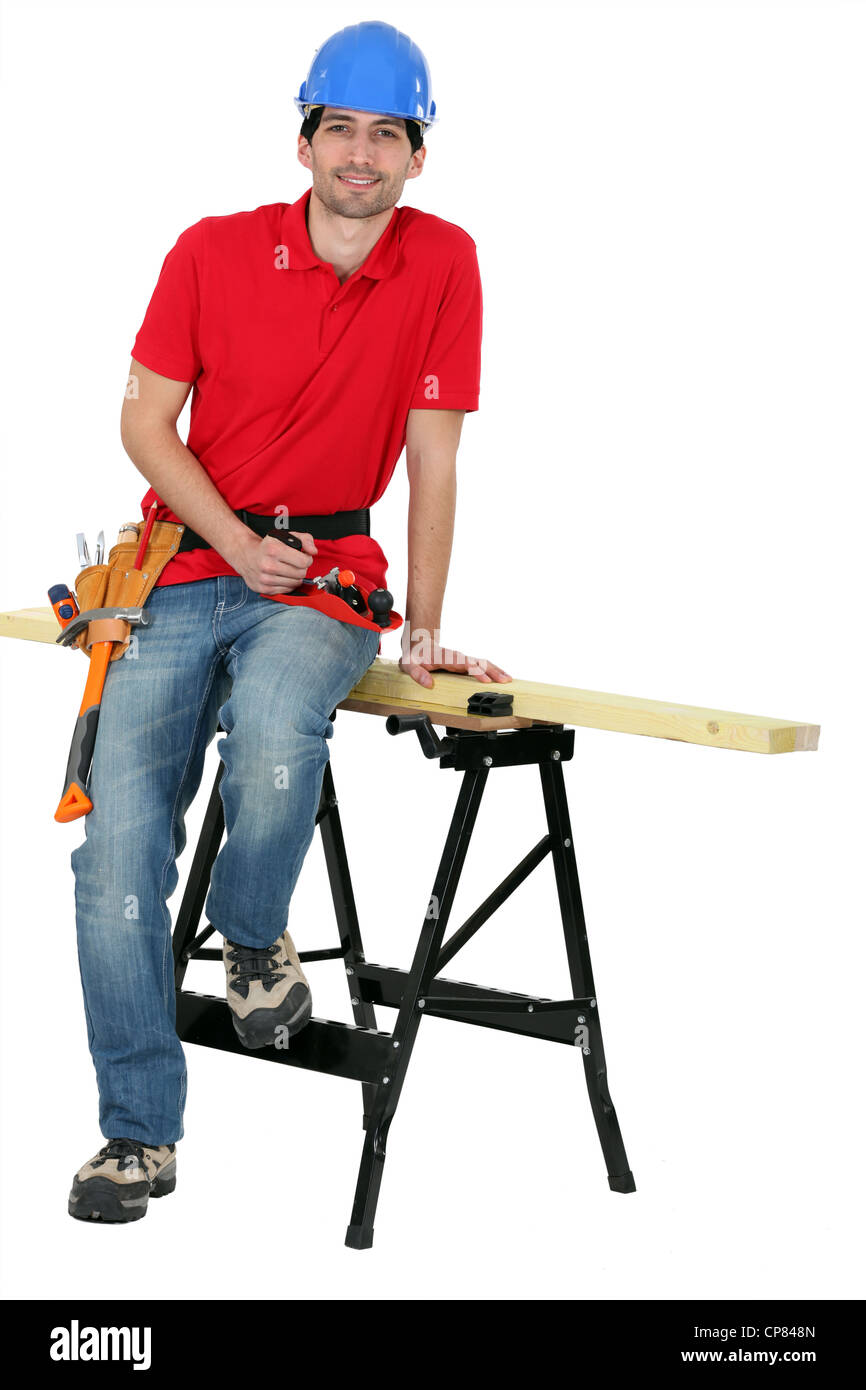 A carpenter seating on a workwrench Stock Photo - Alamy