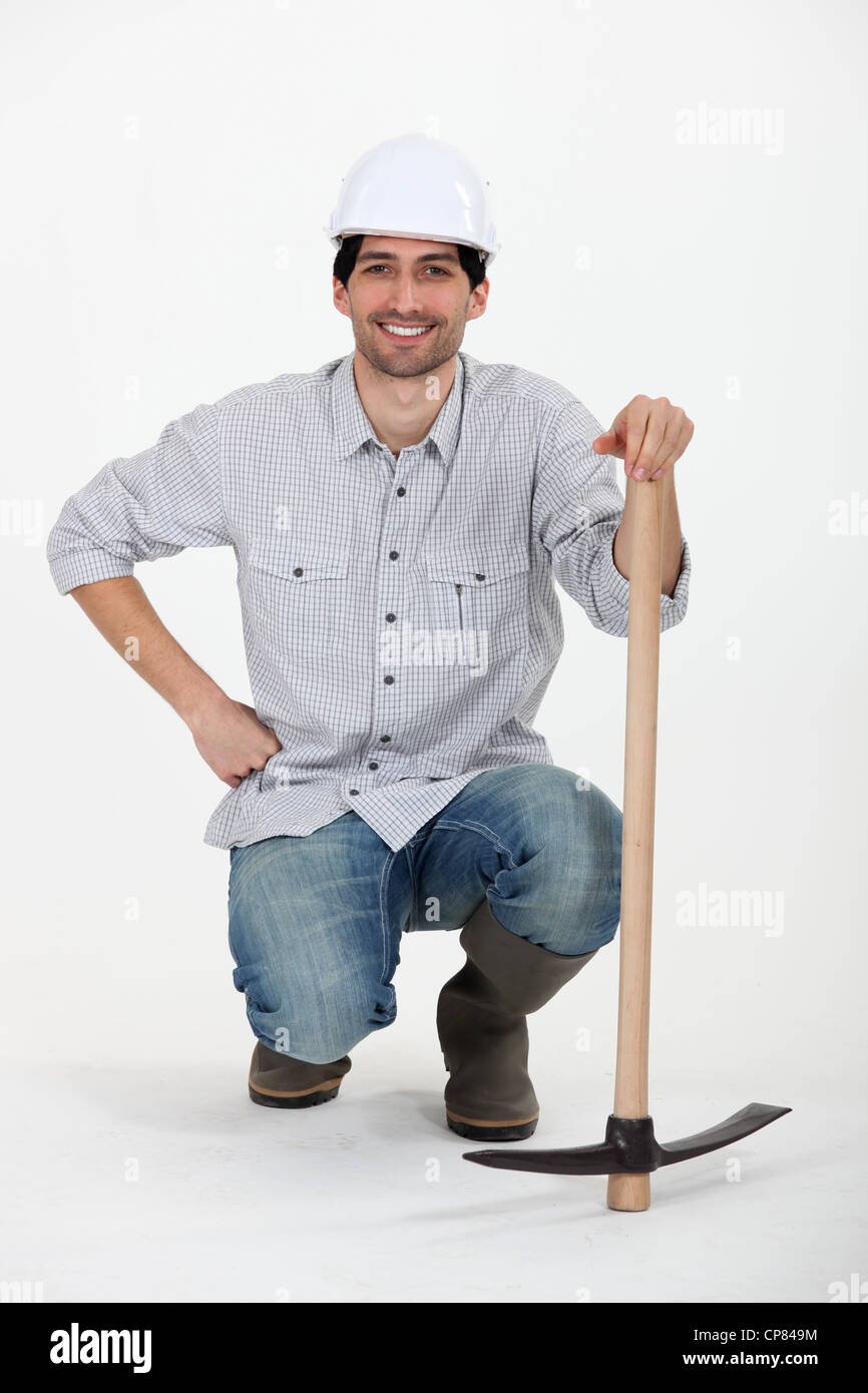 Handy man holding a pick Stock Photo - Alamy