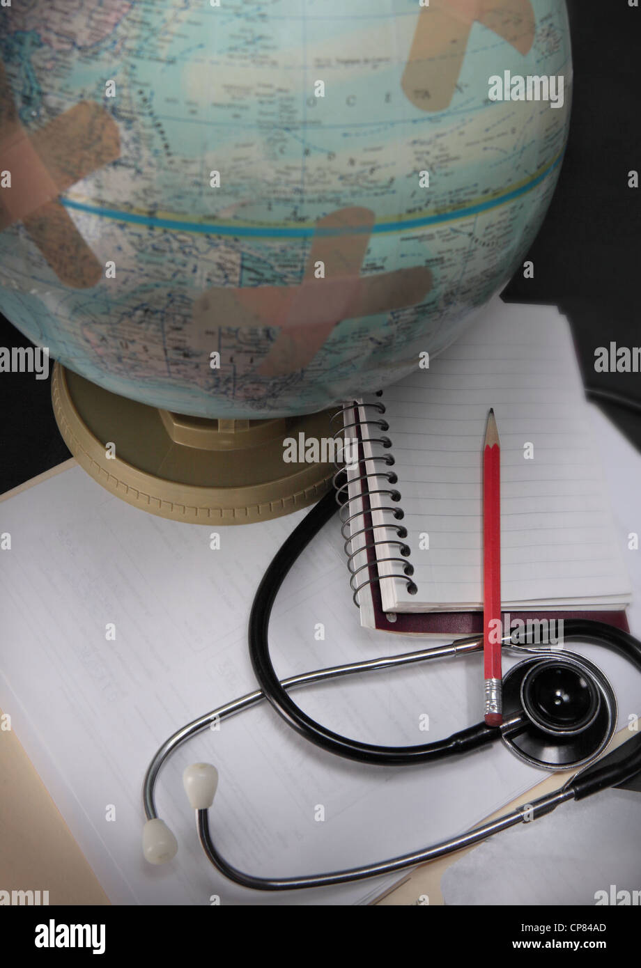 we see a globe with plasters affixed to its surface, a stethoscope ...