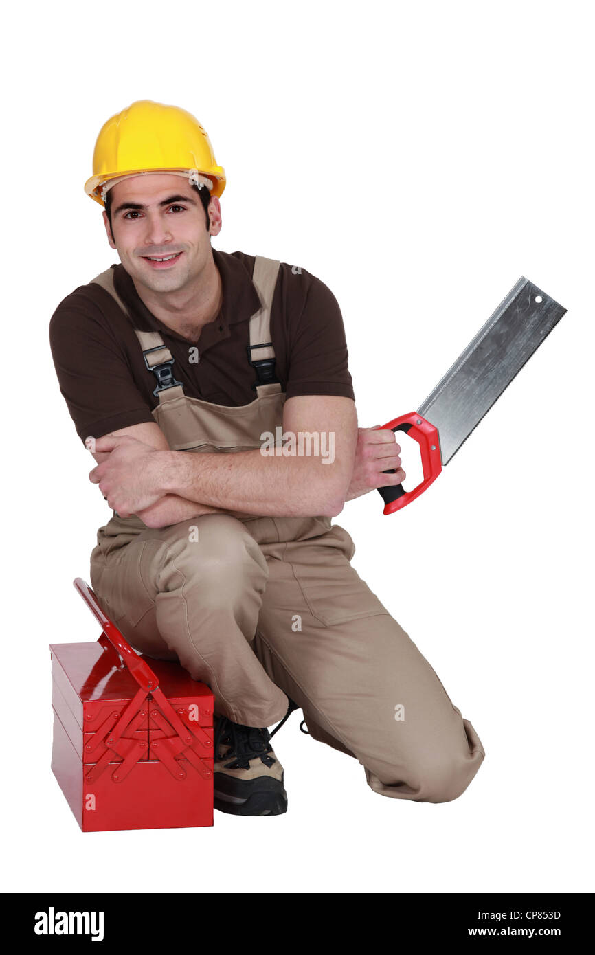 Laborer with saw and toolbox Stock Photo - Alamy