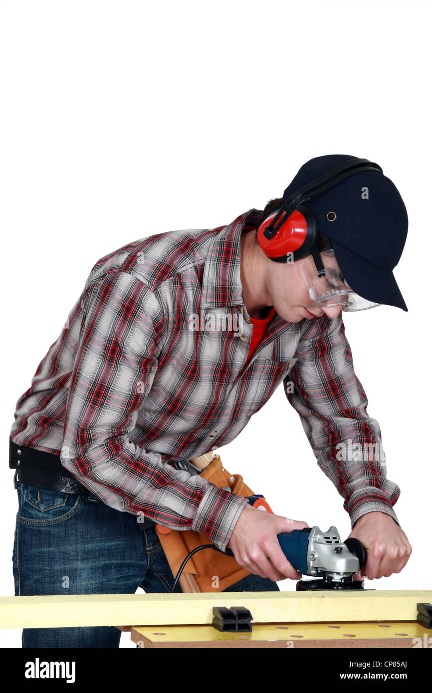 Man using router on plank of wood Stock Photo - Alamy