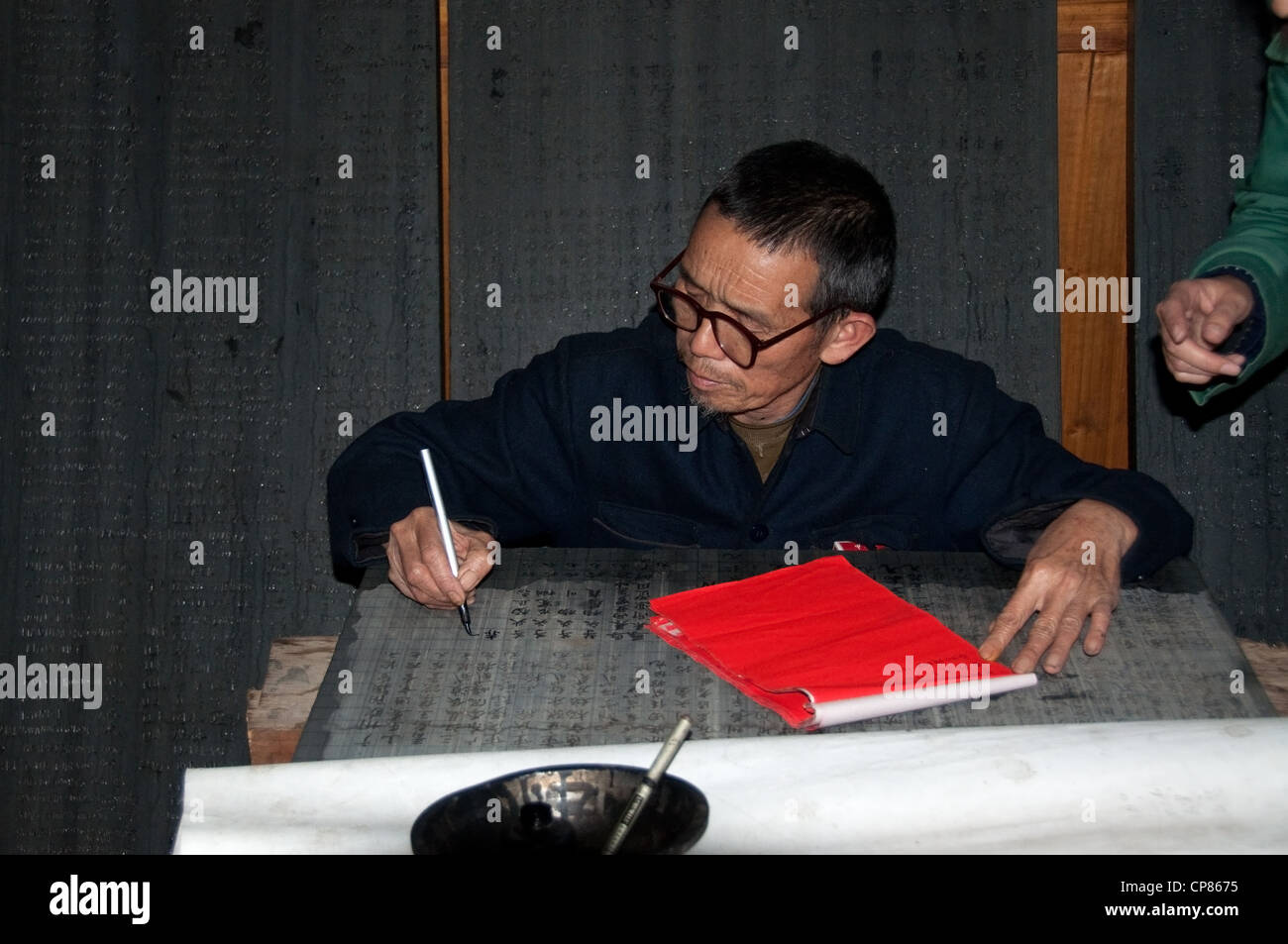 Mature man copying chinese characters on a stone, Chengyang Stock Photo ...