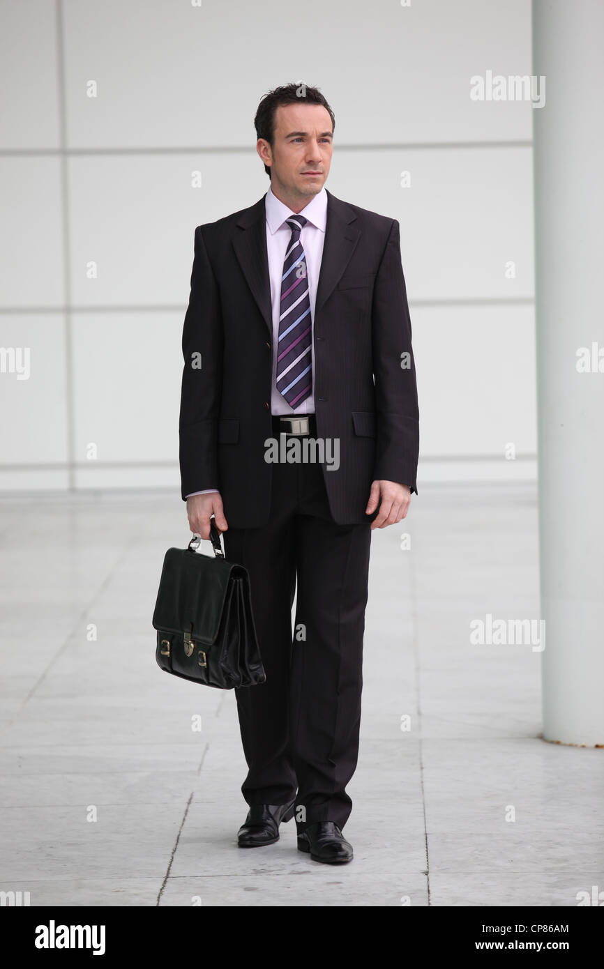 Businessman carrying a briefcase Stock Photo - Alamy