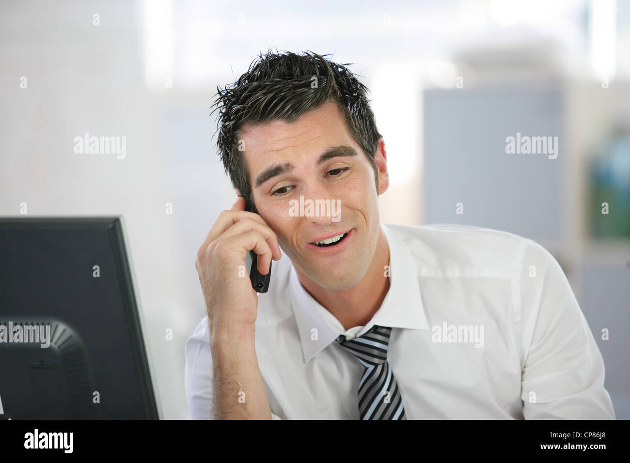Businessman laughing on the phone Stock Photo - Alamy