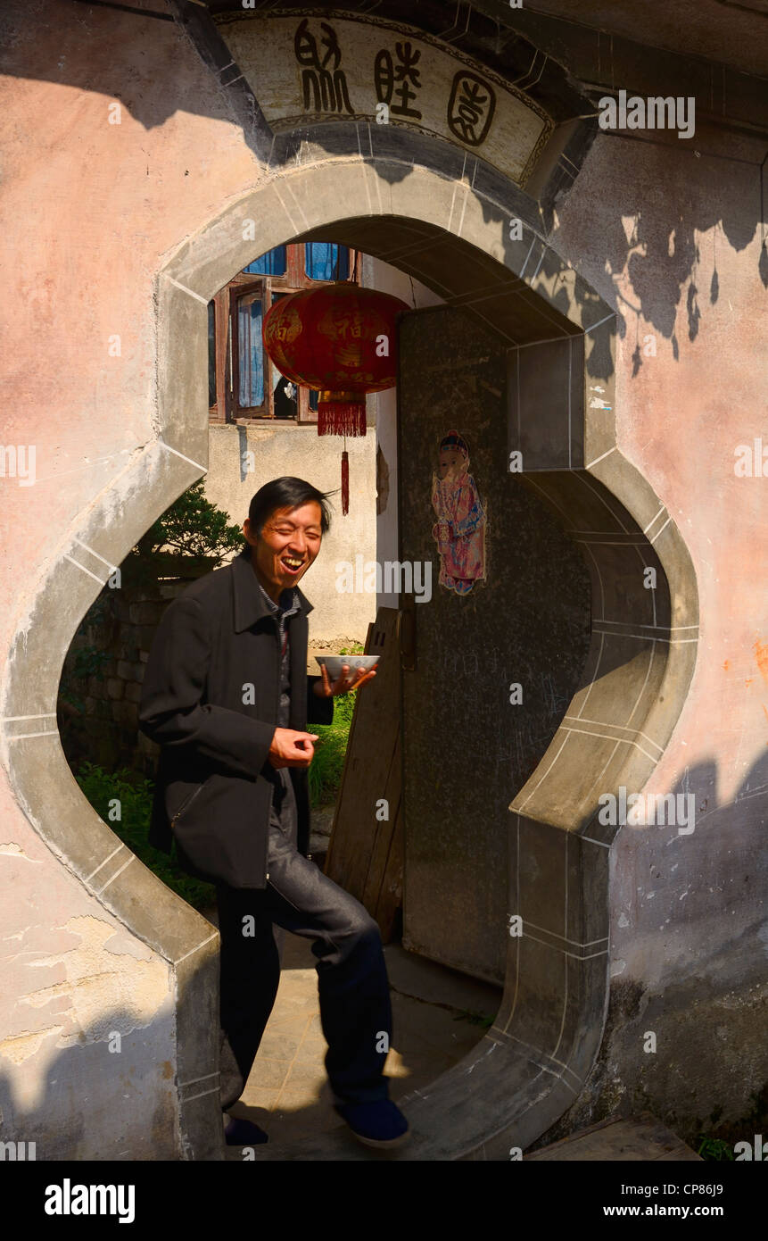 Man eating lunch walking through unique stone keyhole door frame in ...