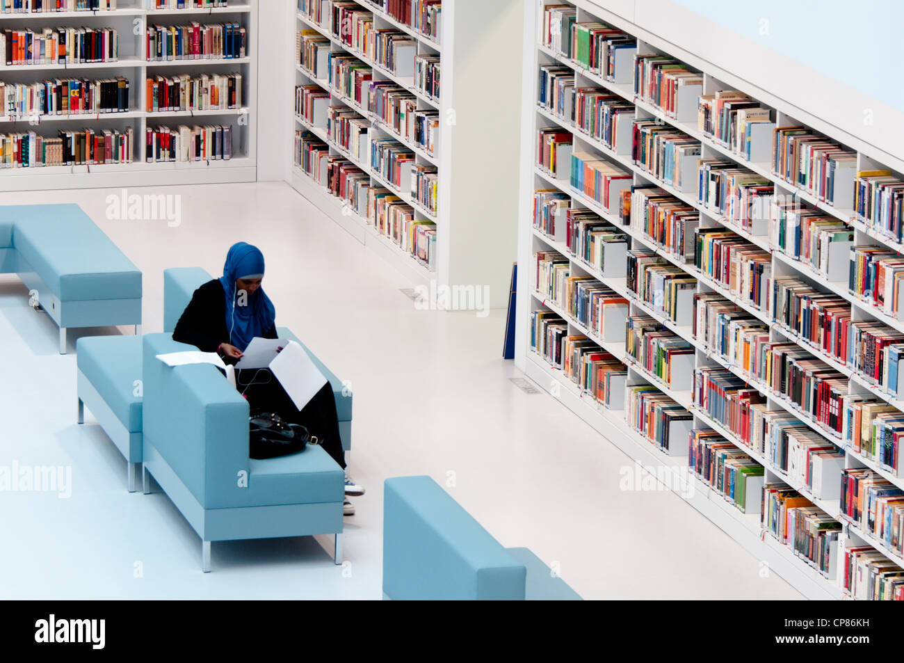 The new municipal public library is used by a young Muslim woman for ...