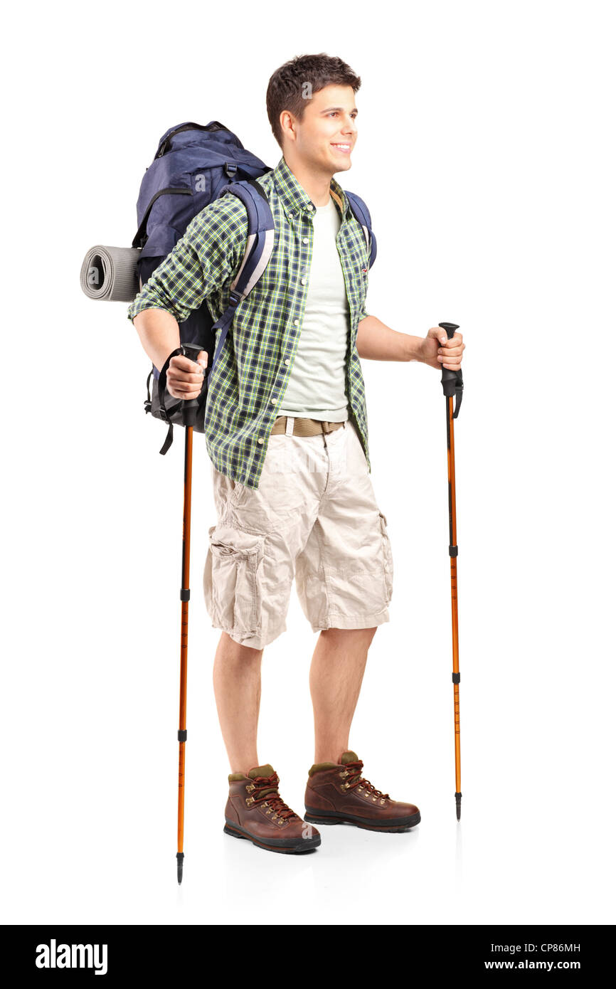 Full length portrait of hiker with backpack holding hiking poles and ...