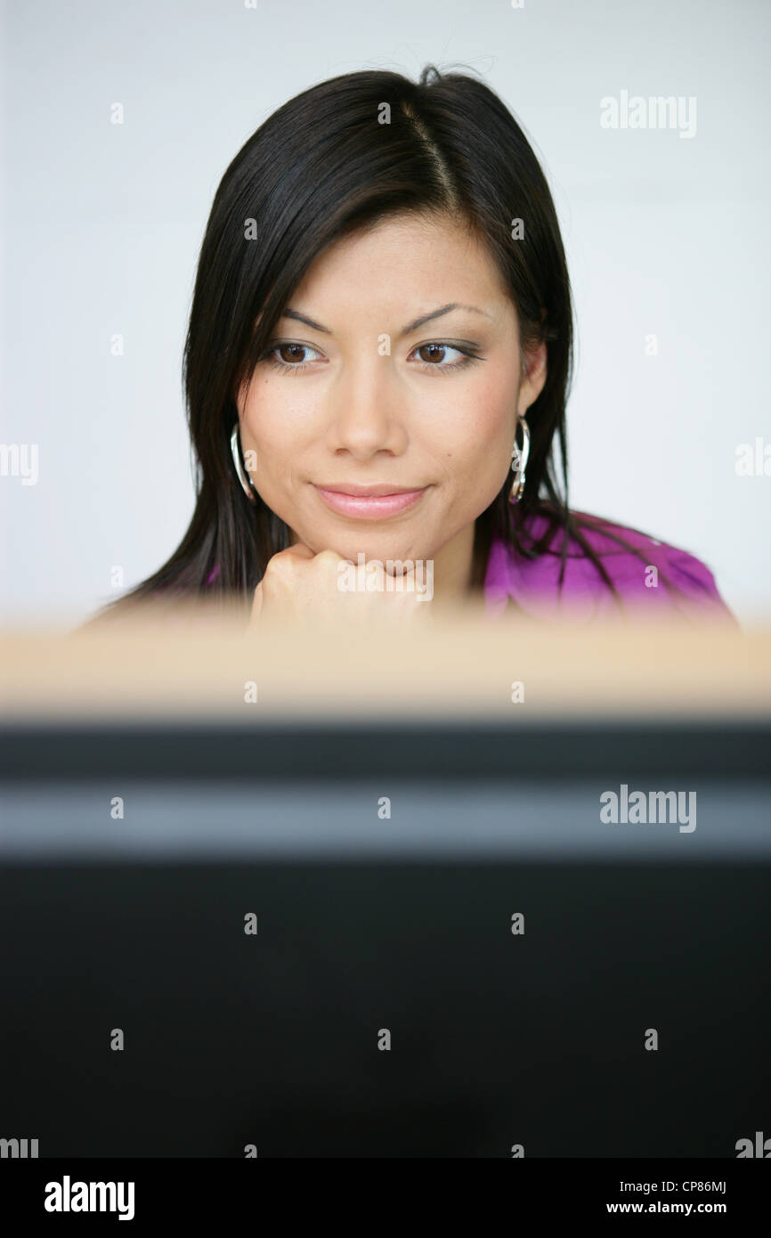 Businesswoman looking at a computer screen Stock Photo - Alamy