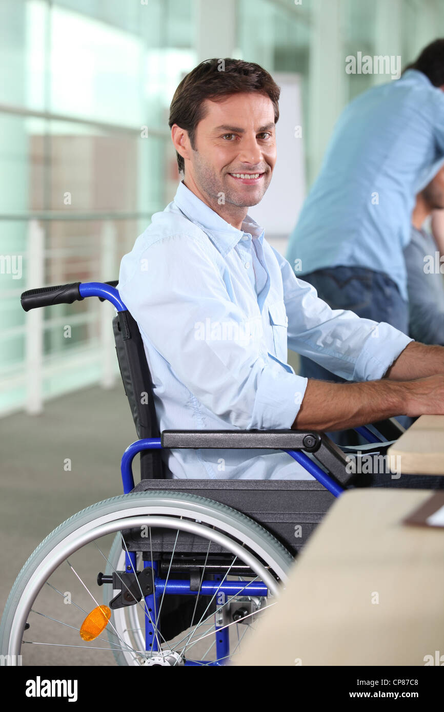 Man working in a wheelchair Stock Photo - Alamy