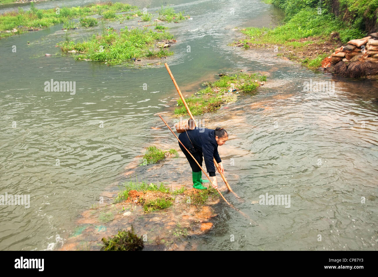 Fishing with a net in a river, Chengyang Stock Photo - Alamy