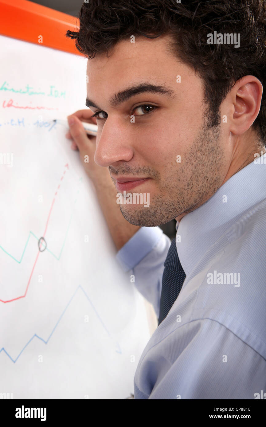 Man writing on a flip chart Stock Photo - Alamy