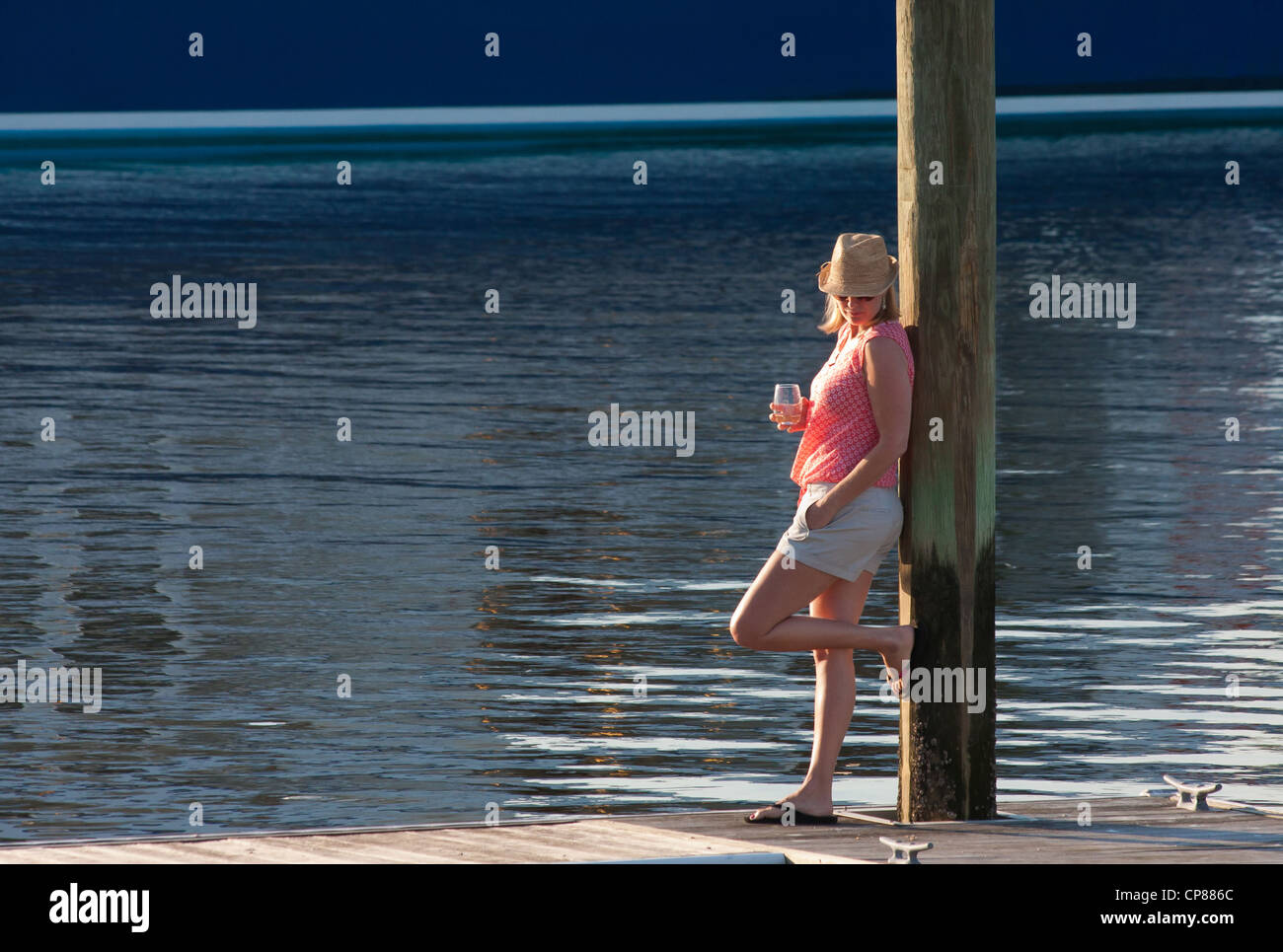 Woman leaning against pole on hi-res stock photography and images - Alamy