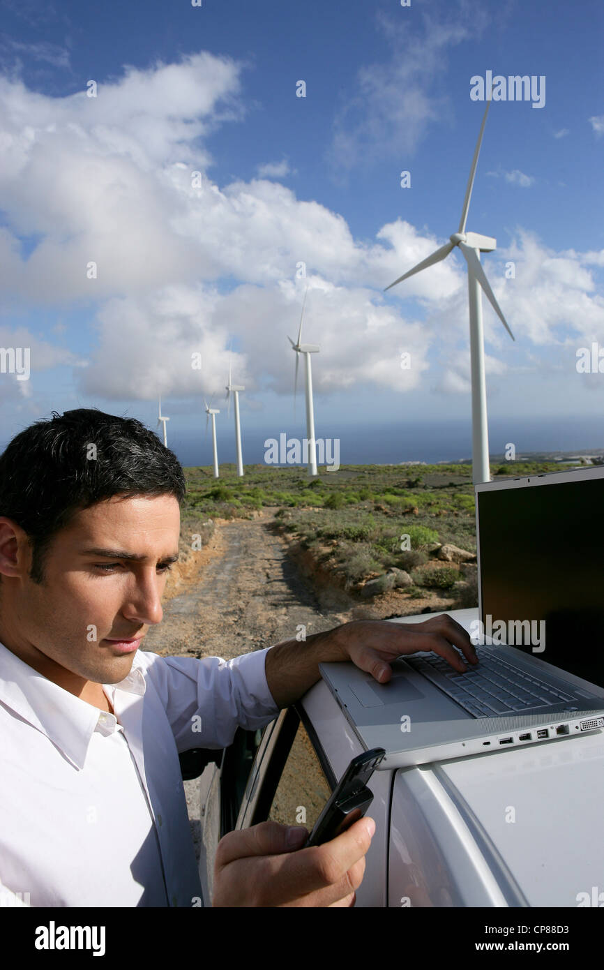 Man stood by wind farm taking readings Stock Photo - Alamy
