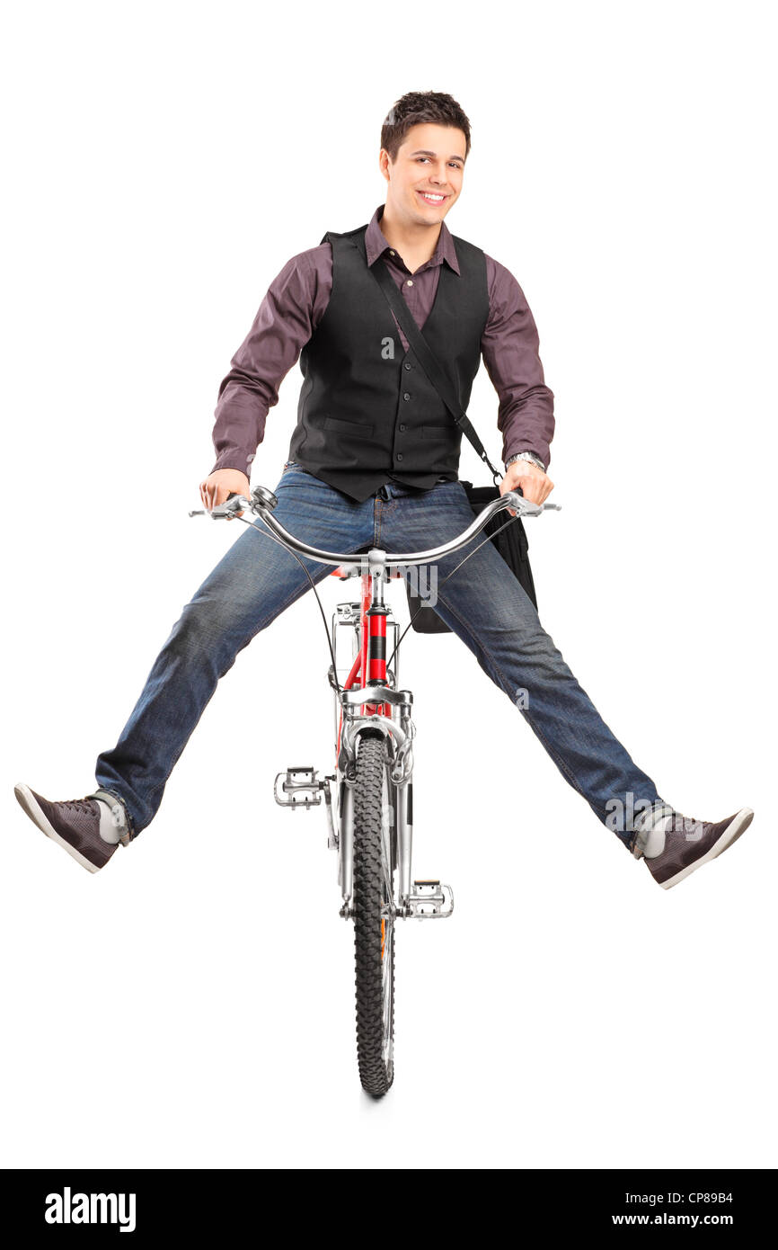 A studio shot of a young happy man riding a bike isolated on white ...