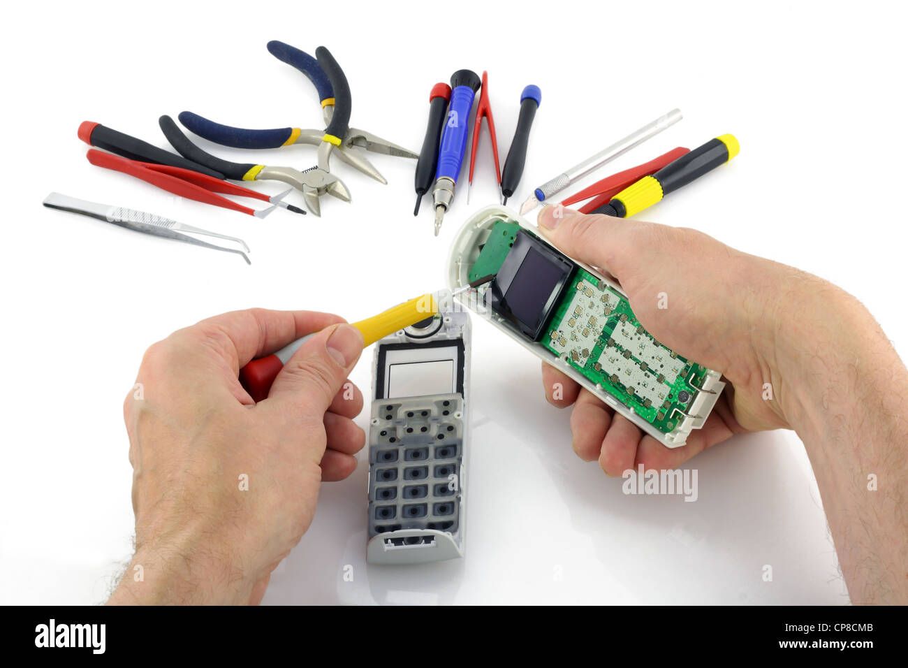The technician repairs a modern telephone. Isolated on white Stock ...