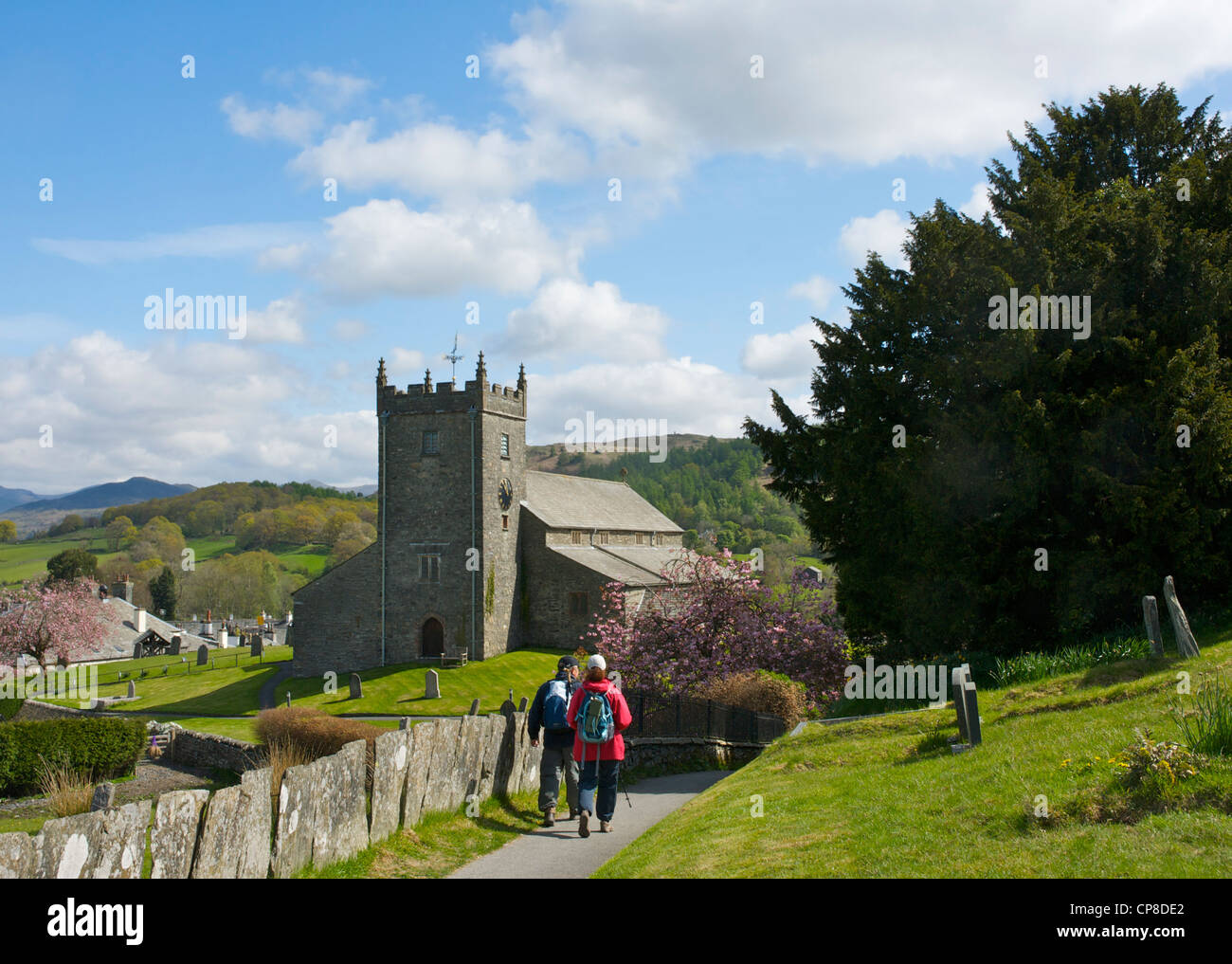 Two people walking towards St Michael & All Angels' Church, Hawkshead ...