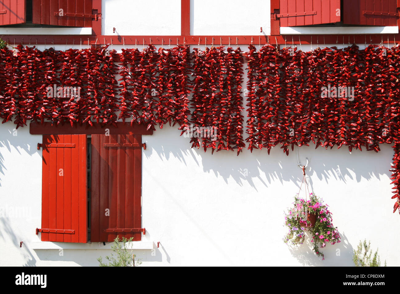 red peppers drying on a house wall Stock Photo - Alamy