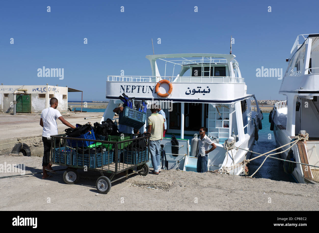 The Egyptians service, preparing equipment for diving, boat on berth ...