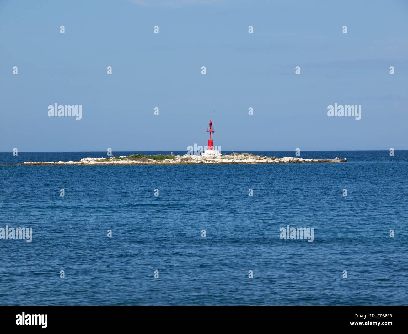 red lighthouse on a small island Stock Photo - Alamy