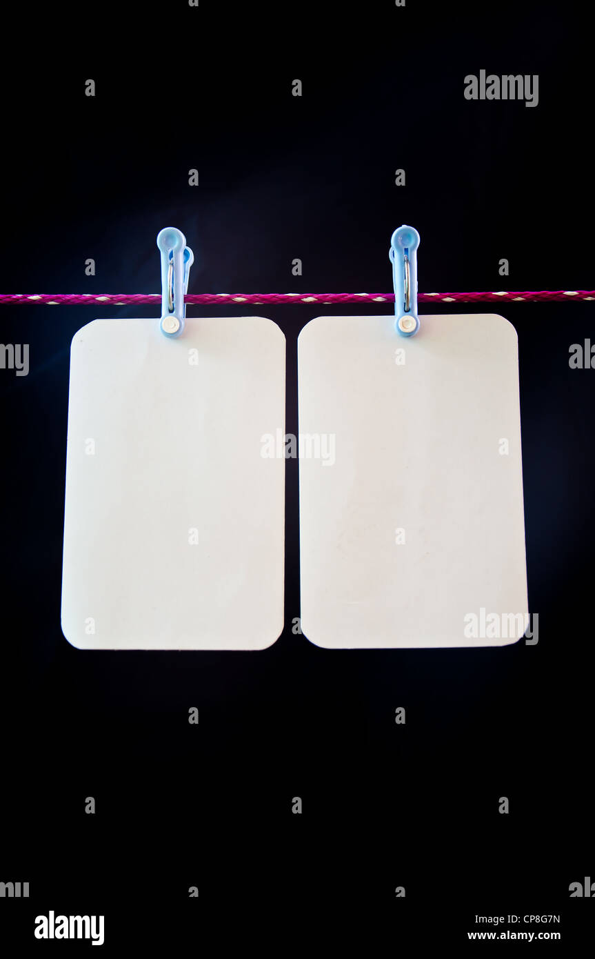hang paper on black background Stock Photo - Alamy
