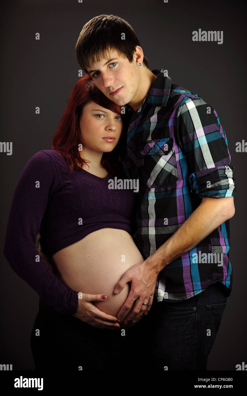 Young Expecting couple isolated on a dark neutral background Stock ...