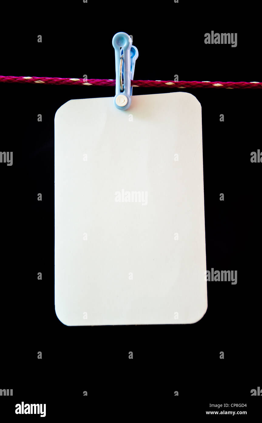 hang paper on black background Stock Photo - Alamy