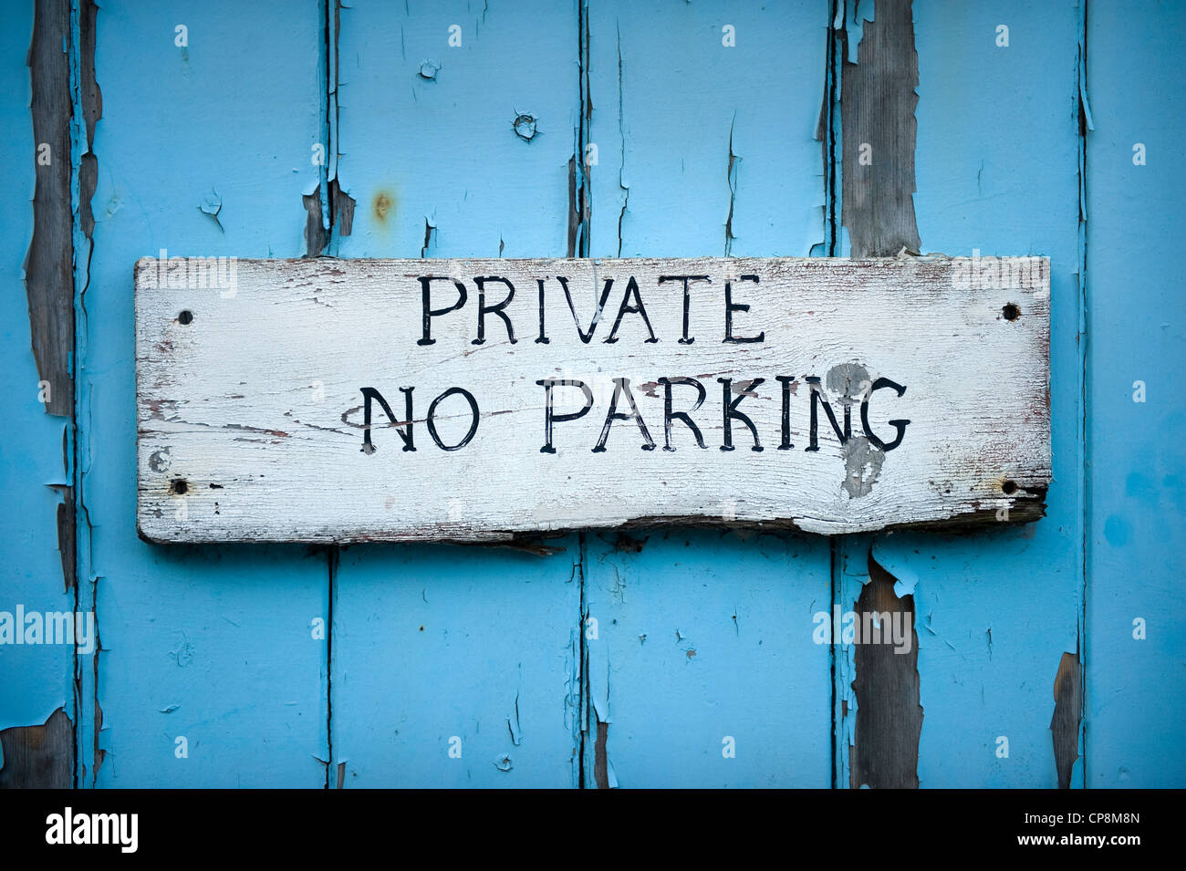 hand painted no parking sign on a blue wooden surface Stock Photo - Alamy