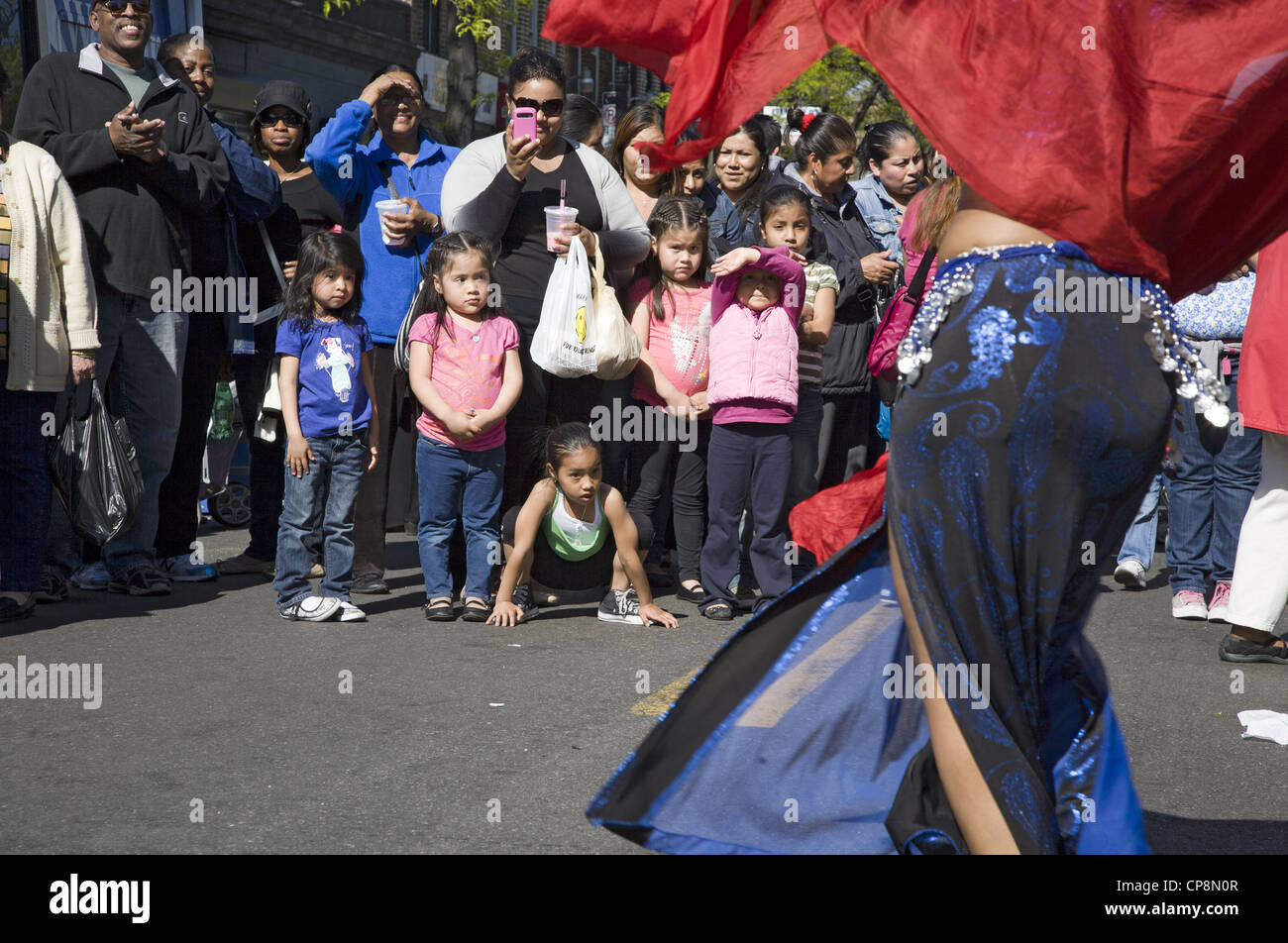 Wide eyed little girls with crowd watch a belly dancer perform at the ...