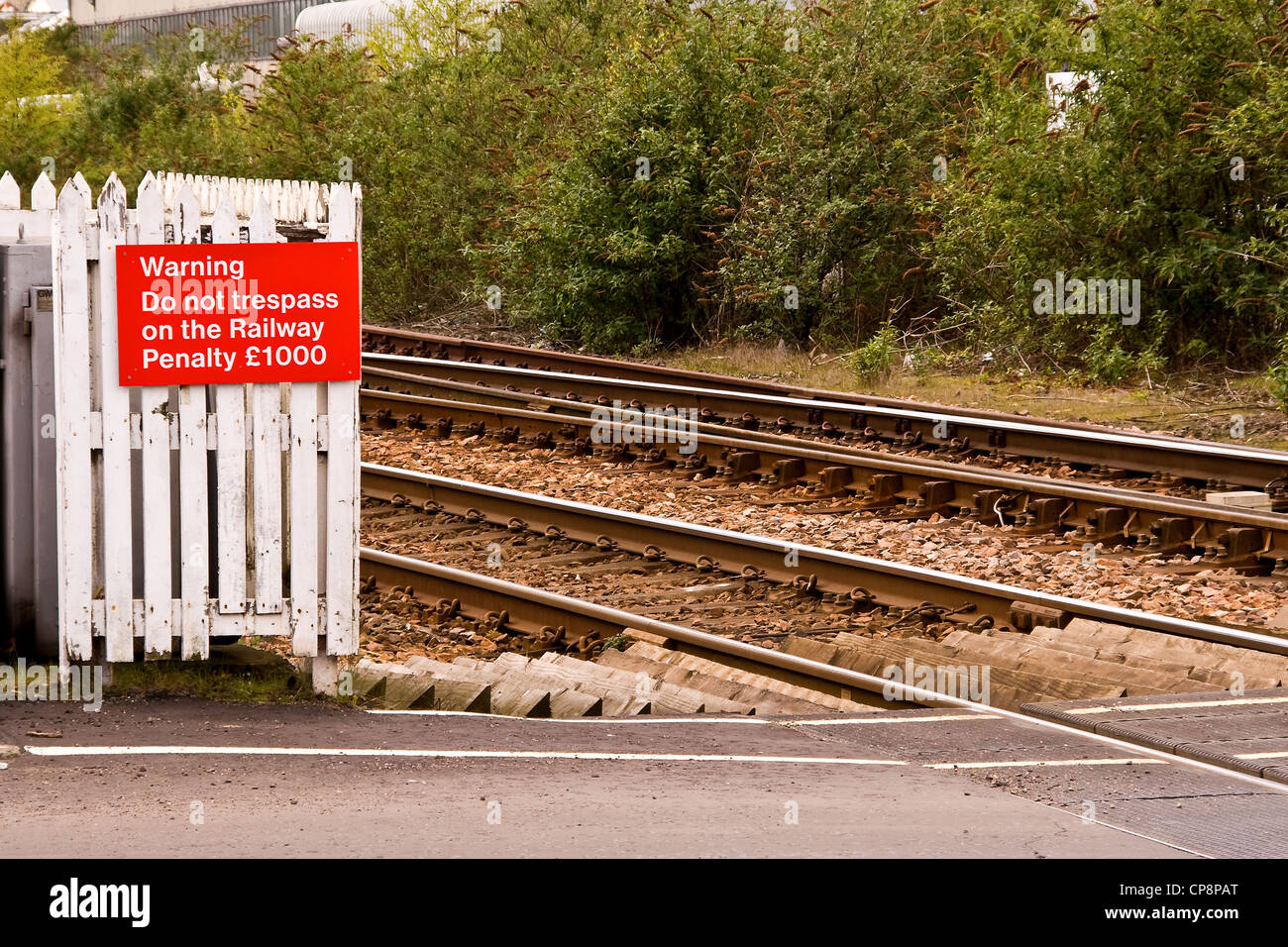 A level crossing sign warning people that they will be fined £1000 if ...