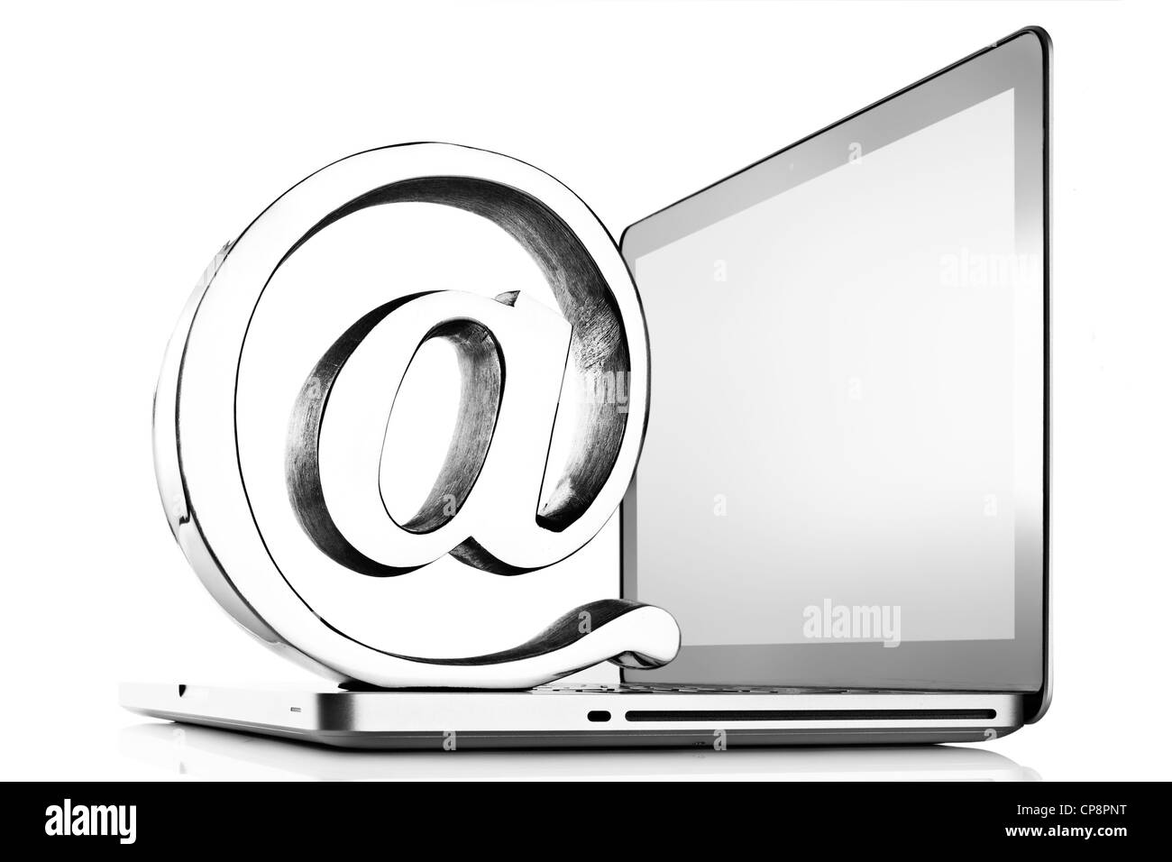 At symbol paper weight with laptop computer Stock Photo - Alamy