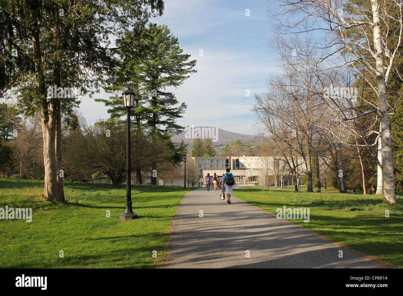 Students walk down a tree-lined path towards a building on the Williams ...